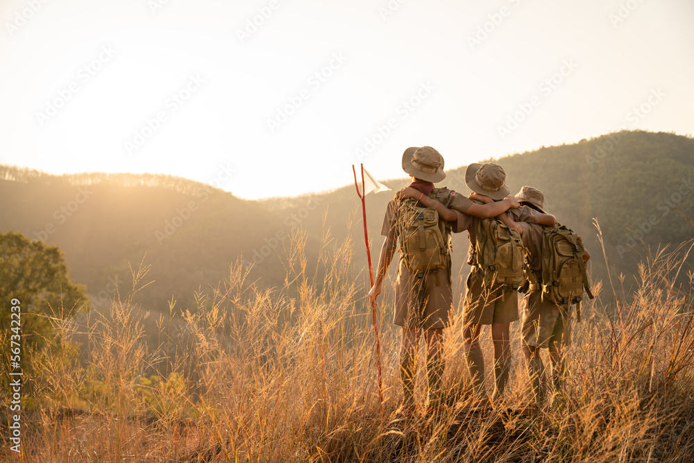 Asian Three Boy Scouts students hiking with backpack stand on the ...