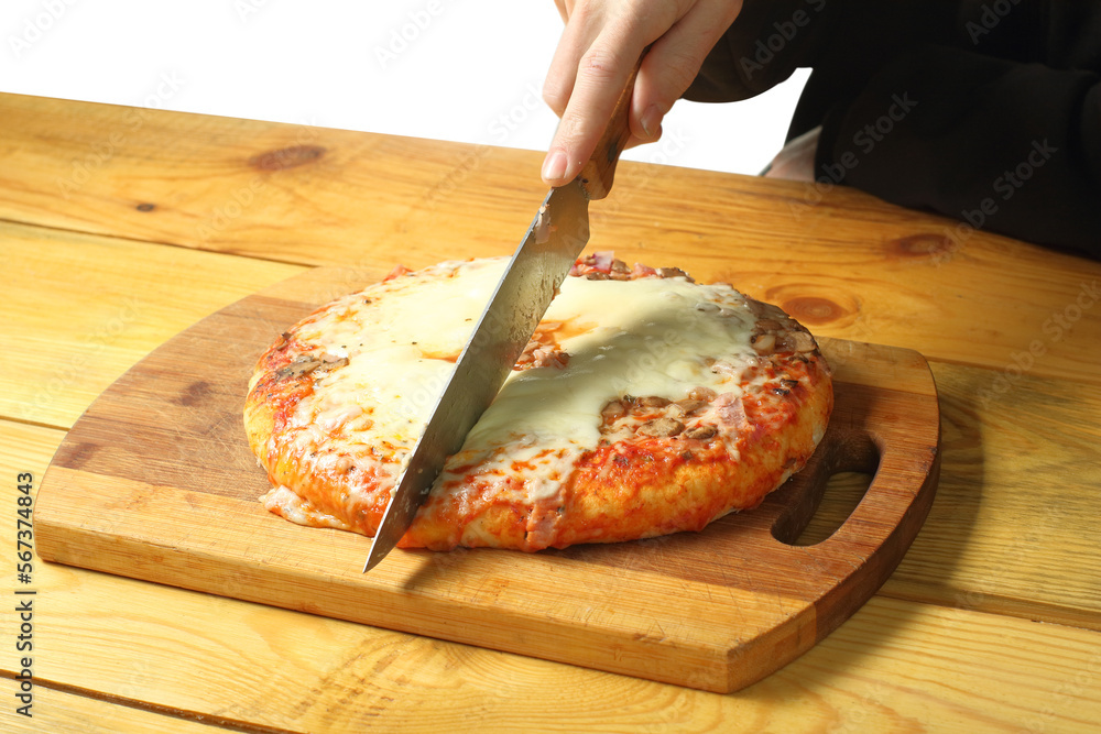 person cutting pizza with a knife Stock Photo | Adobe Stock