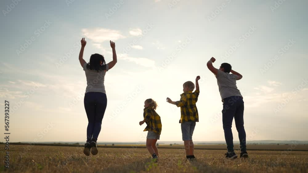 Silhouette of happy family. People holding hands jump up to the sky ...