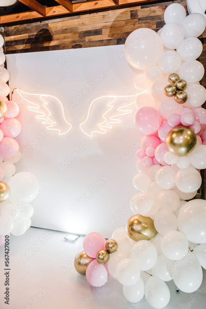 Arch decorated with pink, white and golden balloons, angel wings. Copy space. Celebration ...