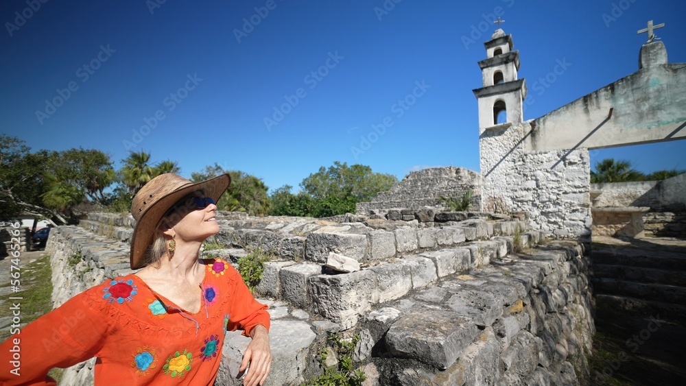 Closeup of mature woman wearing ethnic clothes, sunglasses, hat taking ...