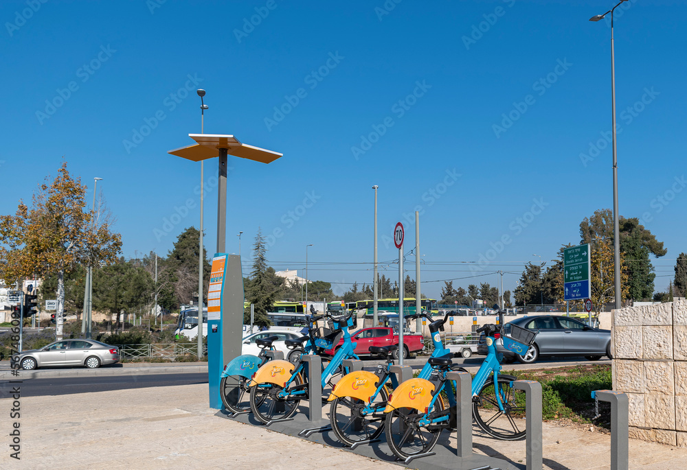 Row of bicycles on the docking station. "Jerufun" - new public bike ...
