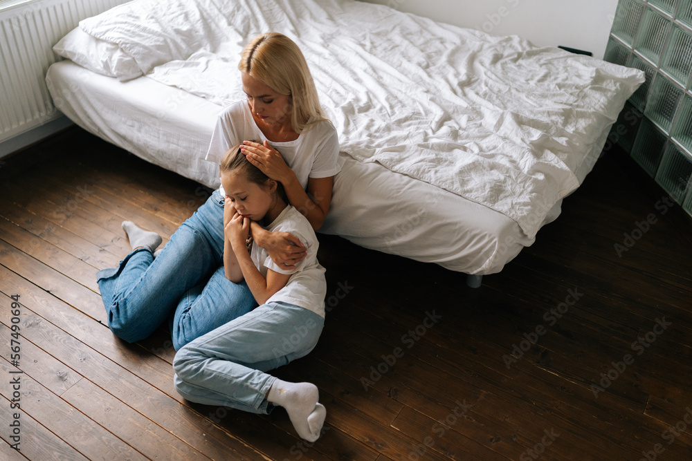 High-angle view of loving caring mother comforting offended afraid ...