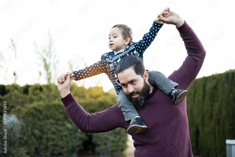 Foto de dark-skinned father and son having fun playing outdoors. child ...