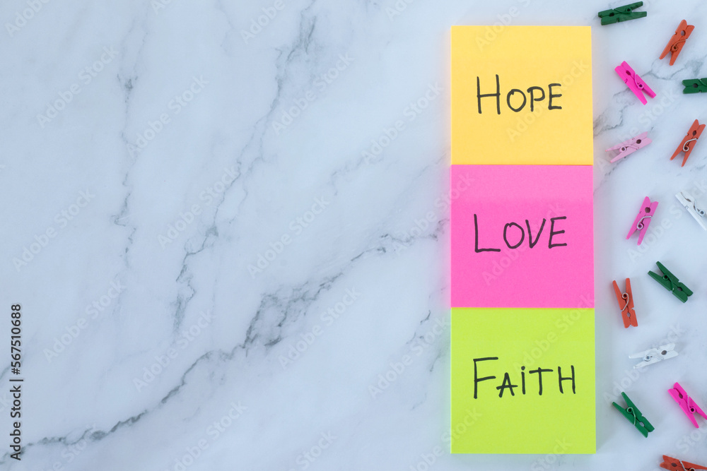Love, hope, and faith handwritten words on colorful notes with ...