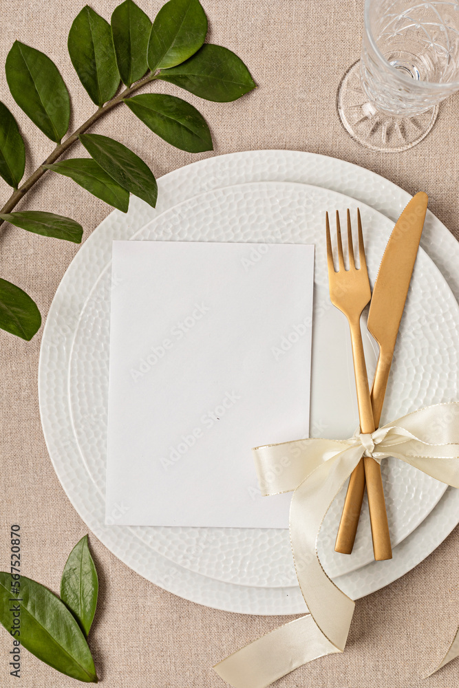 Festive wedding, birthday table setting with golden cutlery and ...
