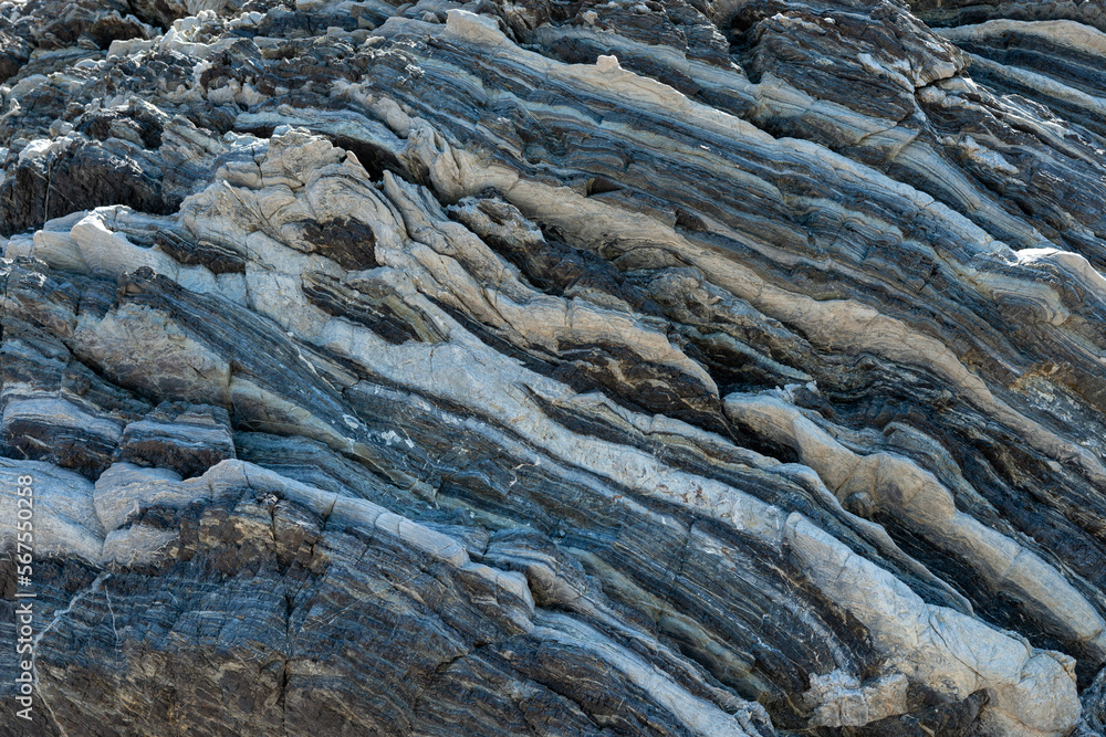 Compressed rock layers formation in various colors and thicknesses, on ...
