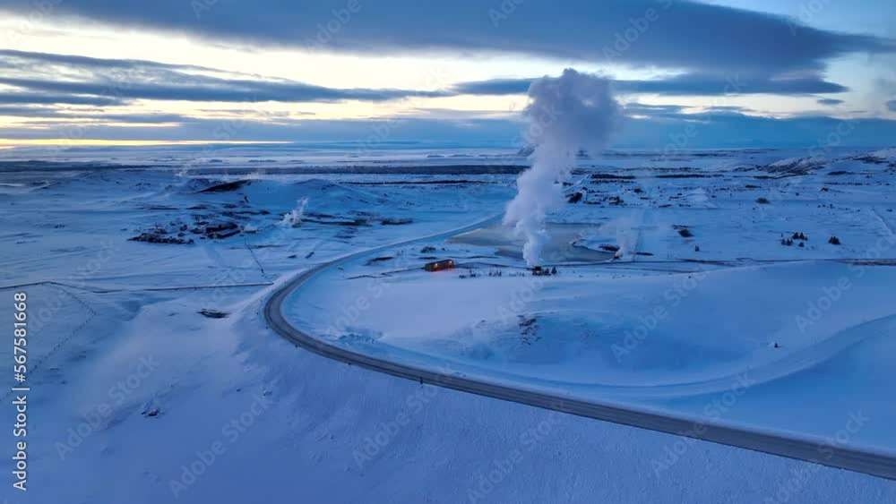 Drone panning shot following highland Myvatn road through hot white ...