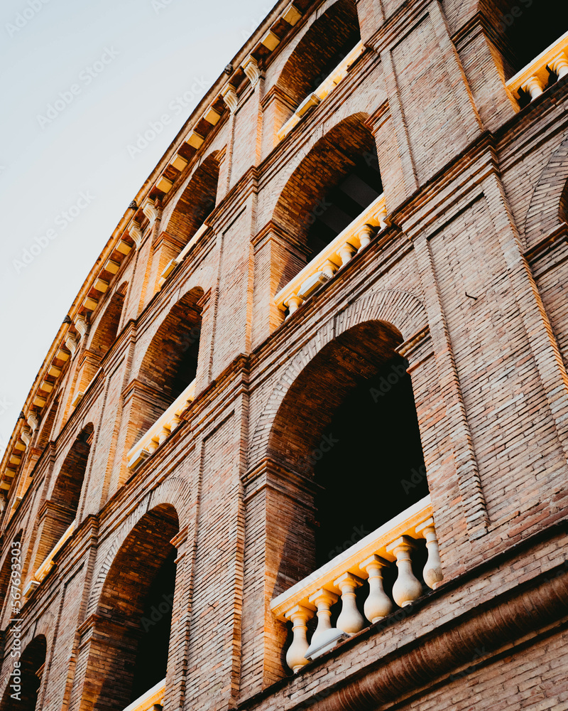 The sun casts its warm light upon the grand stage of an ancient ...