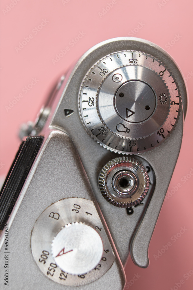 A retro 35mm film camera showing the film winder handle and shutter ...