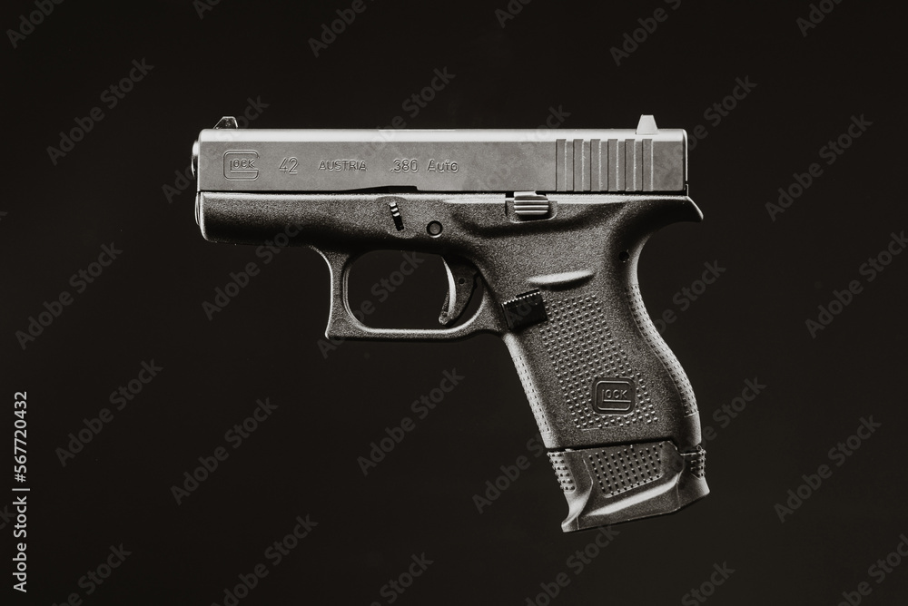 Brno, CZE - 8 24 2022: The Glock 42 is one smallest Glock pistol in caliber 380. Side view. Dark ...