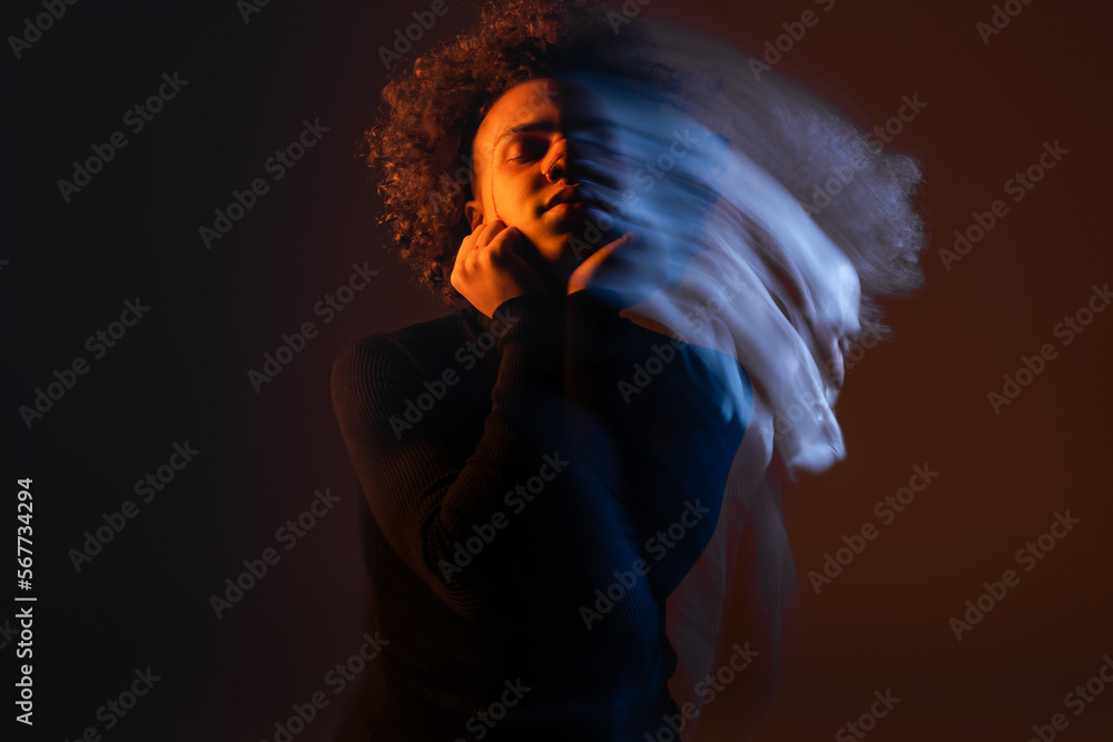 double exposure of injured african american man with hands near ...
