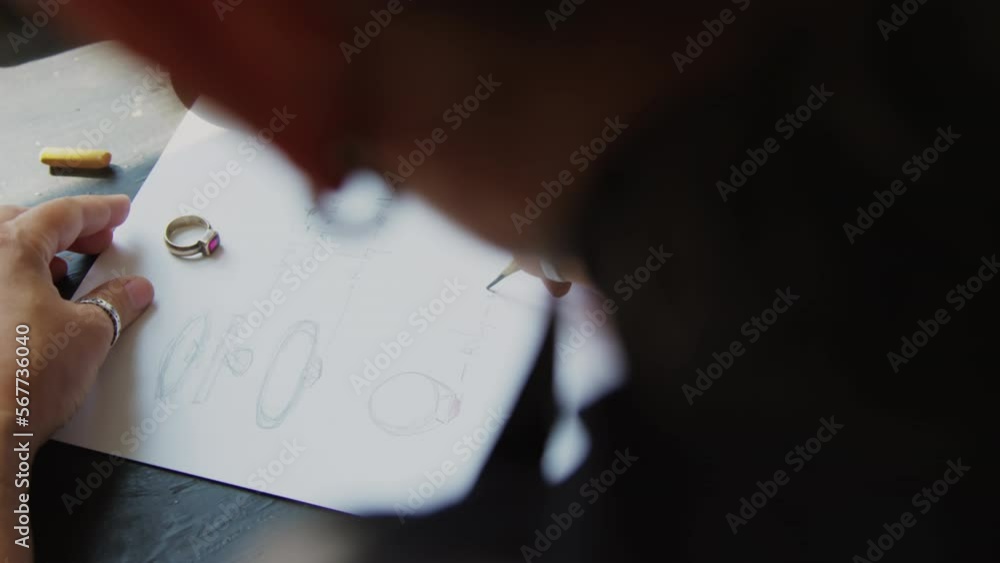 Goldsmith designing ring making sketch on paper Stock Video | Adobe Stock