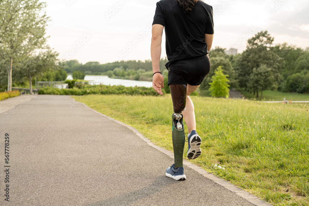 Details of a walk of a young man with prosthetic leg, young man with ...