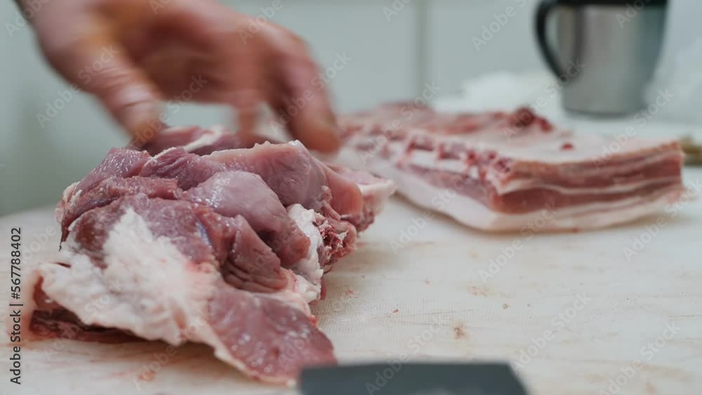 Vídeo do Stock: Close-up of a butcher's hands carving a piece of raw ...