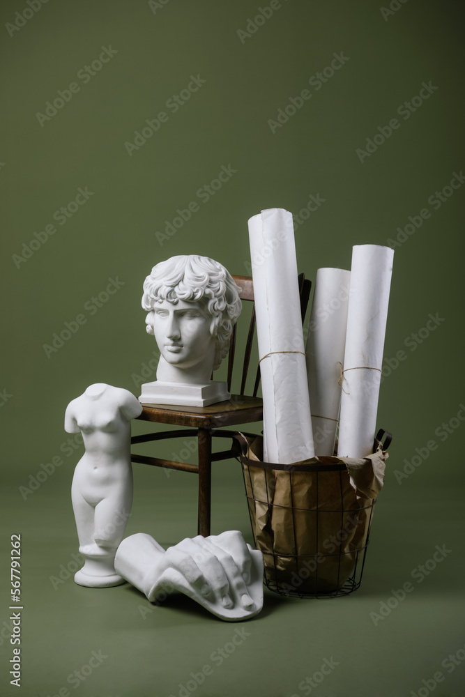 Still life of an assorted plaster figurines and rolled up artwork Stock ...