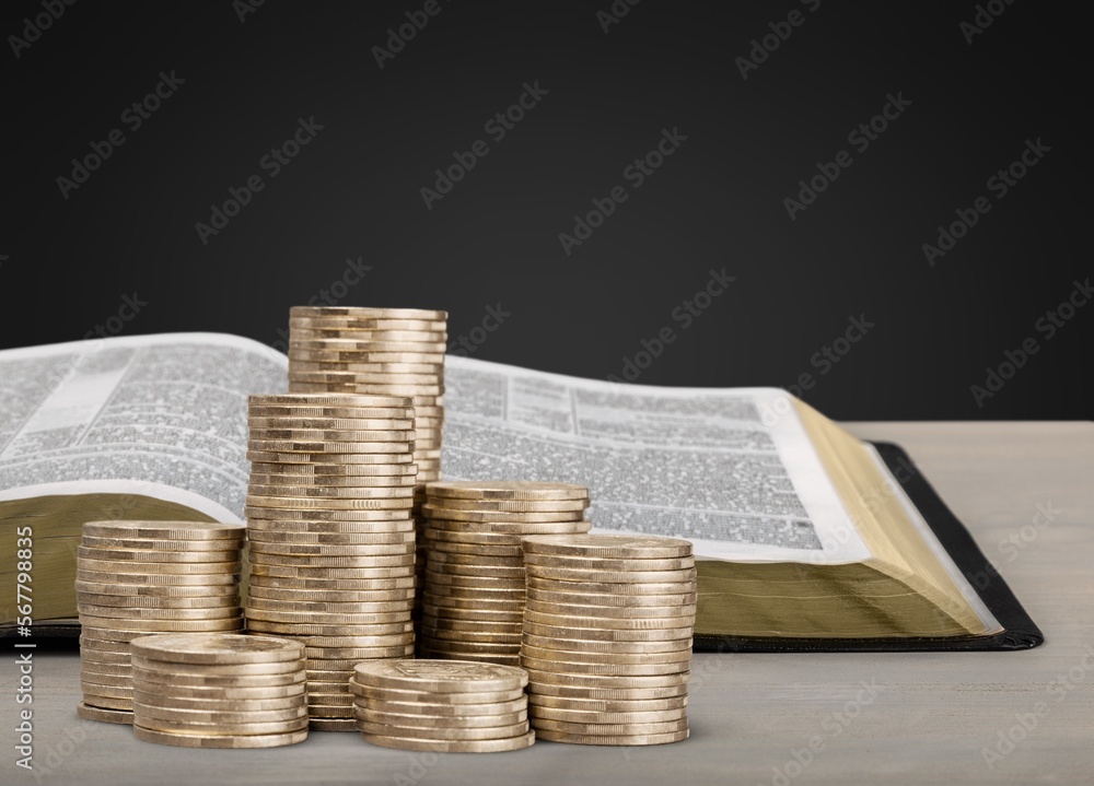 Holy Bible book and stack of coins Stock Photo | Adobe Stock