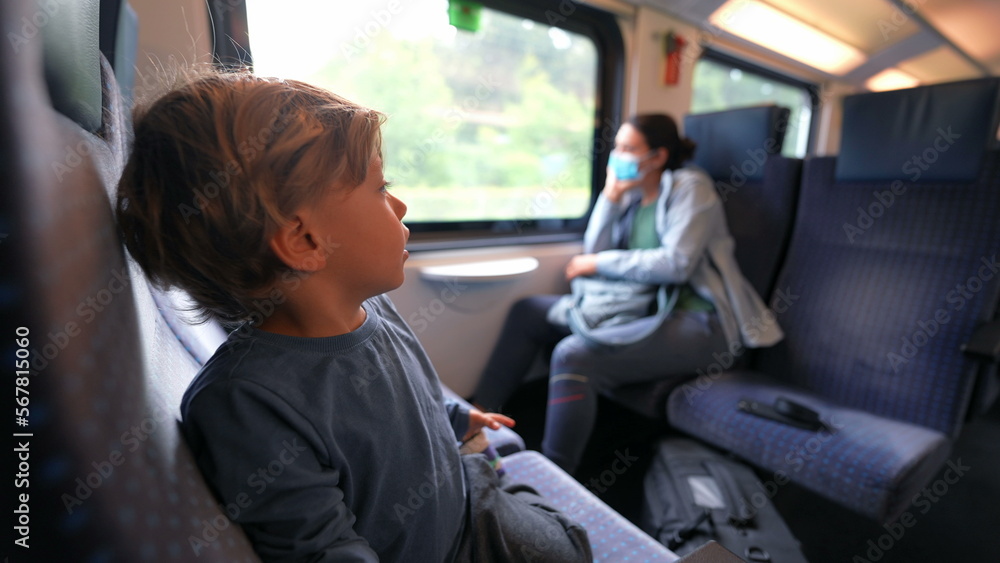 Behaved little boy sitting on train child travels by tansportaiton with ...