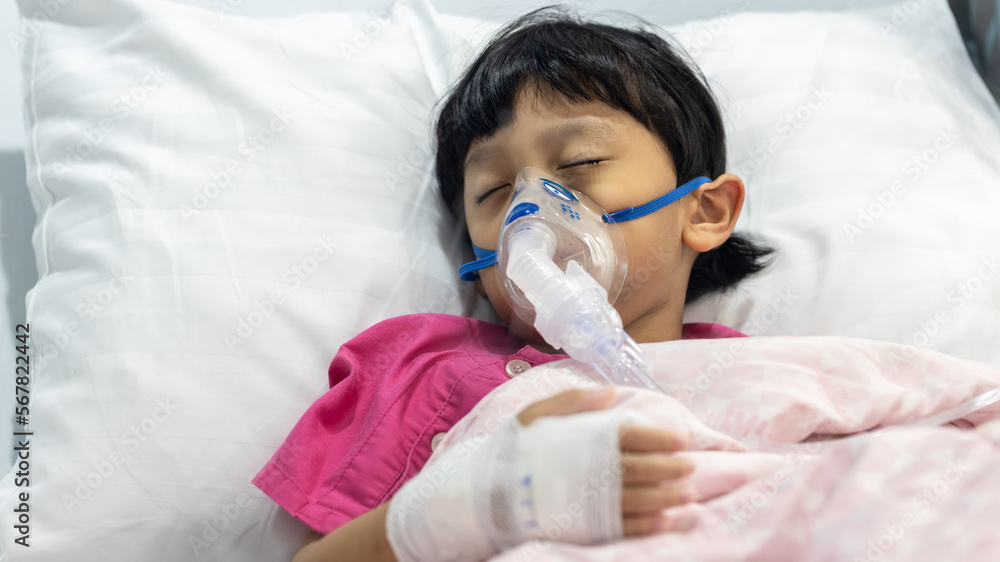 Sick boy inhalation therapy by the mask of inhaler. Baby has asthma and ...