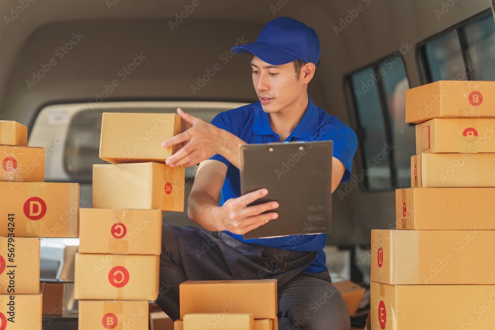 Delivery man asia people checking portable delivery device with parcel ...