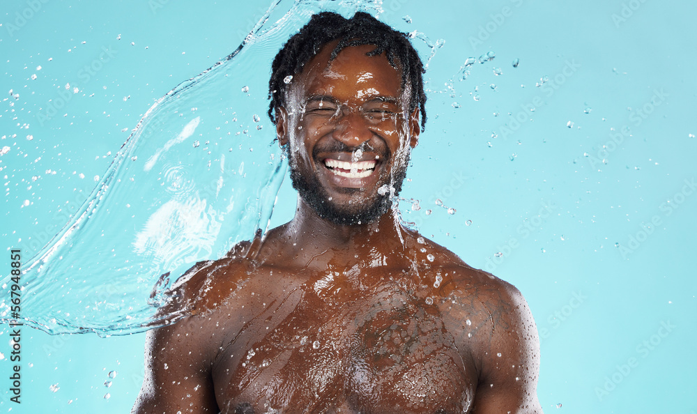 Water splash, beauty and black man isolated on blue background for face cleaning, body shower ...