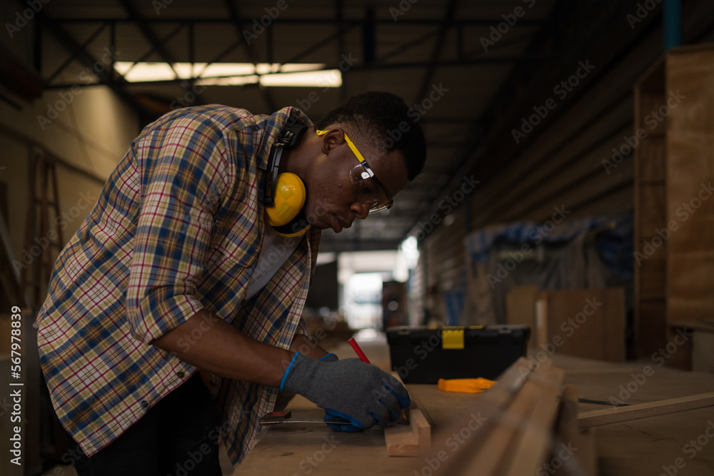 Black African Carpenter professional craftsmen wear safety gear. He was ...