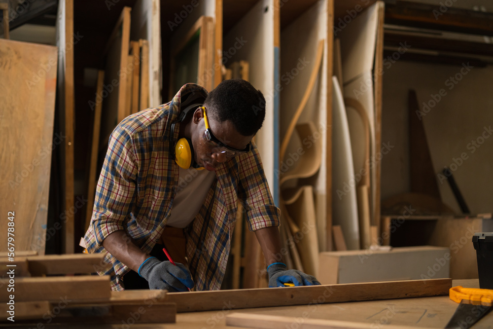 Black African Carpenter professional craftsmen wear safety gear. He was ...