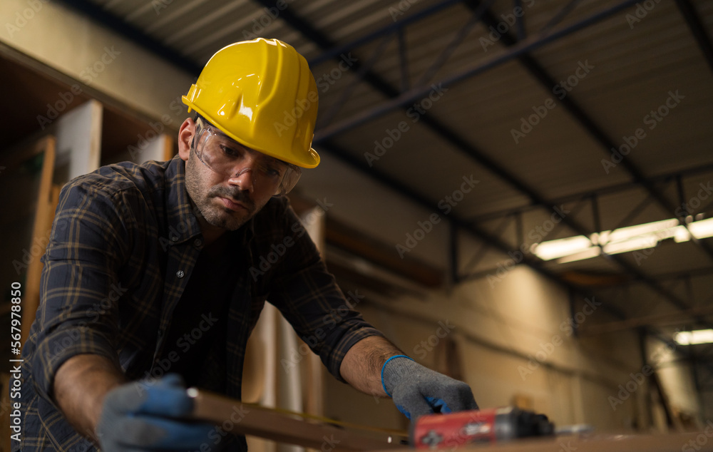 Professional carpenter craftsmen wear safety gear. He was measuring the ...