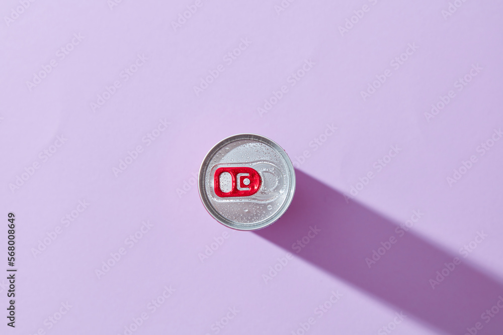 can with red pull tab, water drops, condensate on purple background ...