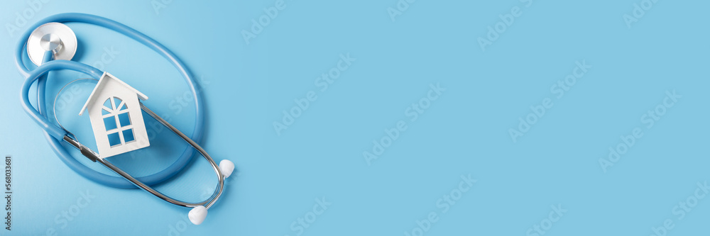 house and medical stethoscope on blue background banner, home ambulance ...