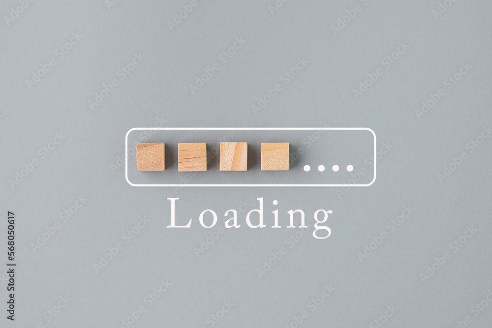 Wooden cube block with the word LOADING for loading progress. loading ...