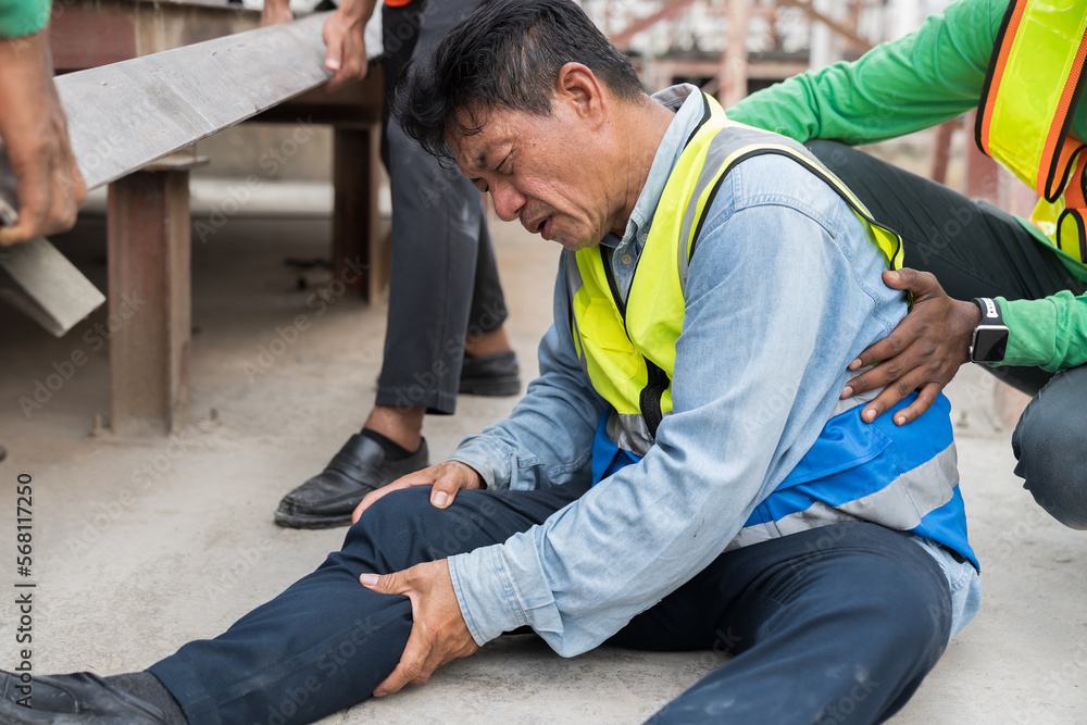 Asian male worker accident at his leg at construction site. Industrial ...