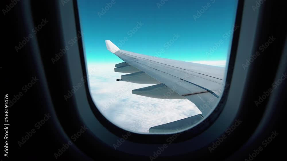 Airplane flight. Wing of an airplane flying above the clouds. Looking ...