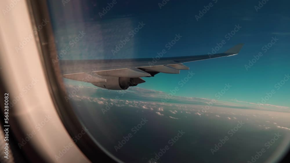 Airplane flight. Wing of an airplane flying above the clouds. Looking ...