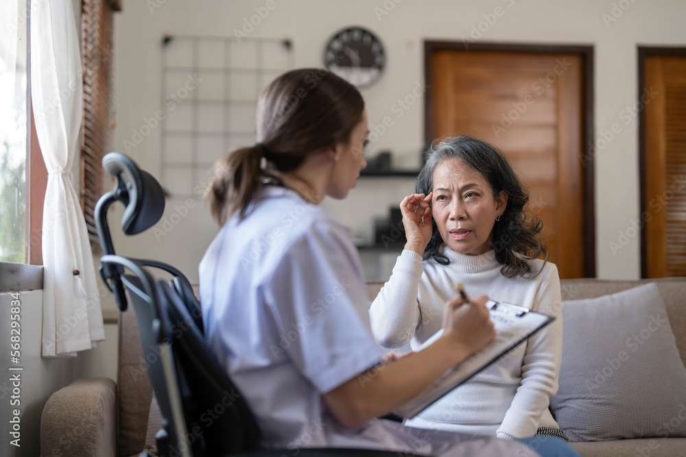 Asian female patient undergoing health check up while female doctor ...
