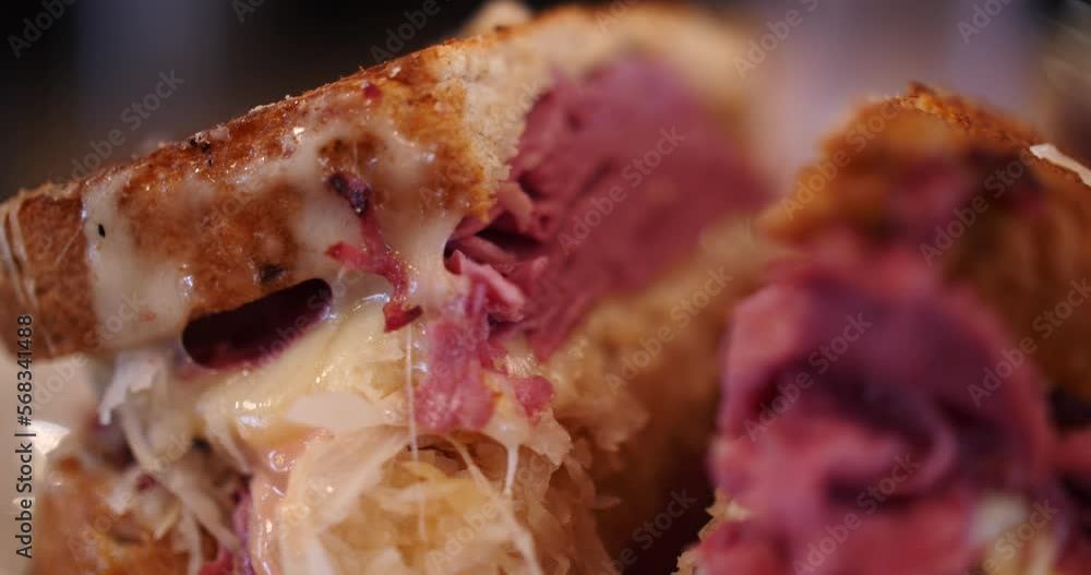Triple-decker Ruben corned beef sandwich extreme close-up melted cheese ...