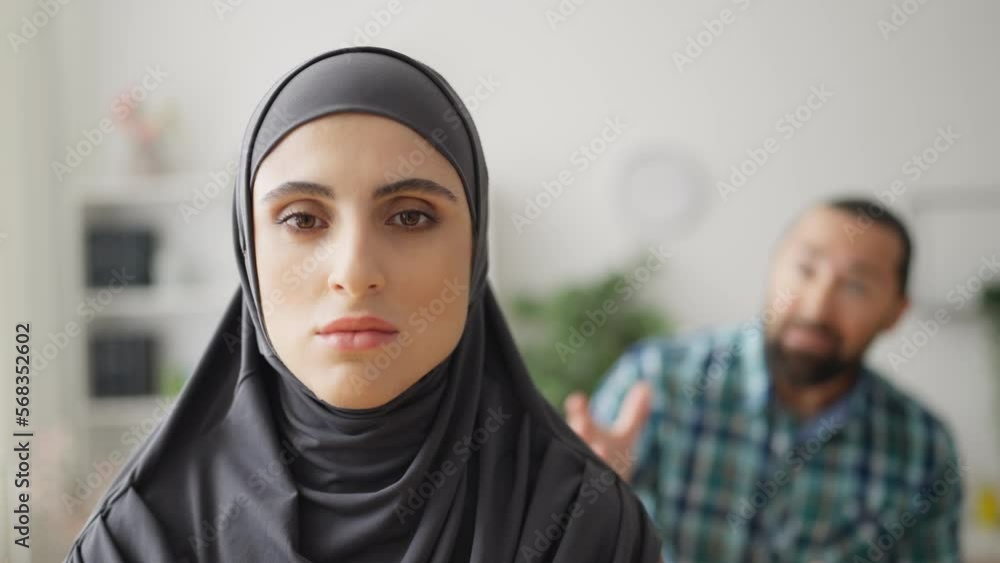 Middle-aged muslim man screaming at his wife in hijab, verbal abuse ...