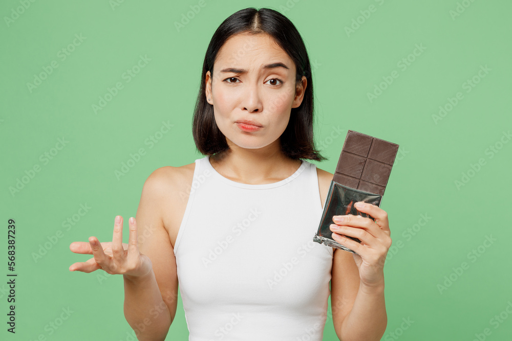 Young confused sad woman wears white clothes hold in hand dark ...