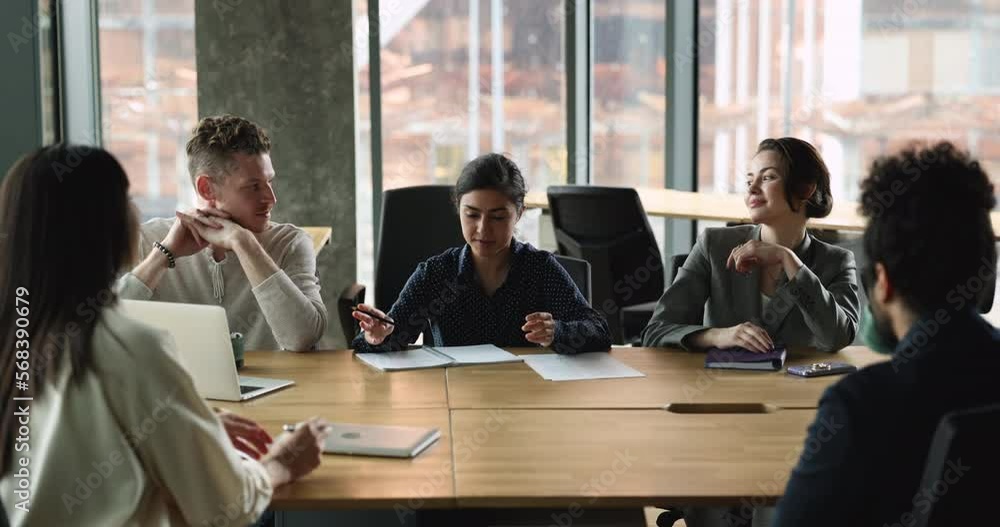 Confident Indian team leader speaking to employees at corporate meeting ...