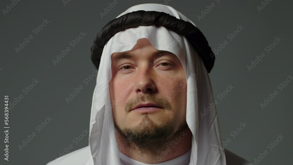 Portrait close up of successful arab man in traditional outfit, wearing ...