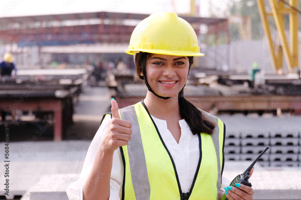 Female worker wearing a safety helmet smiling thumbs up. Stock Photo ...