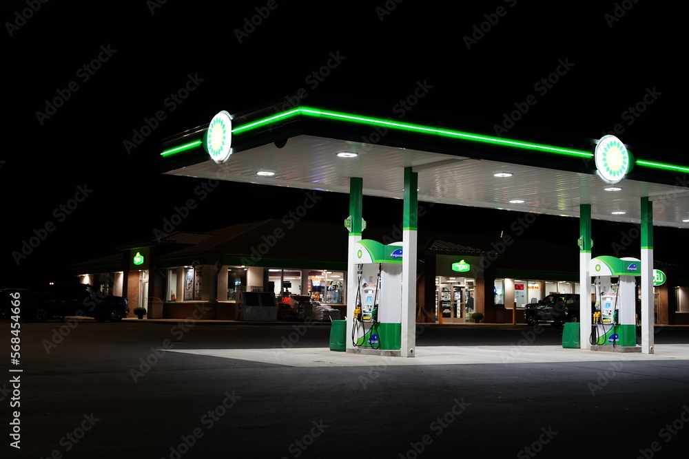 Foto de BP British petroleum fuel station lights up the night to serve ...