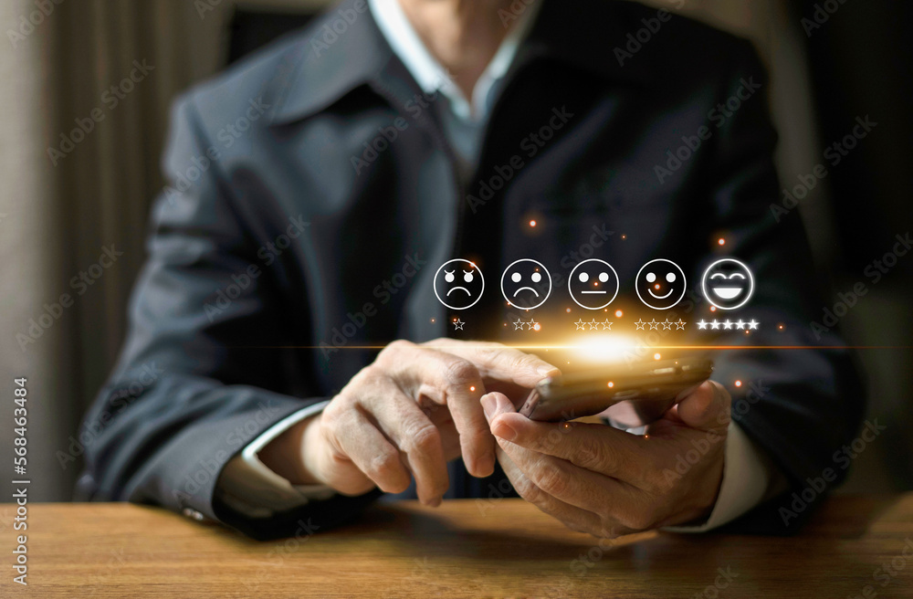 Businessman pressed the smile face emoticon on the virtual touch screen ...