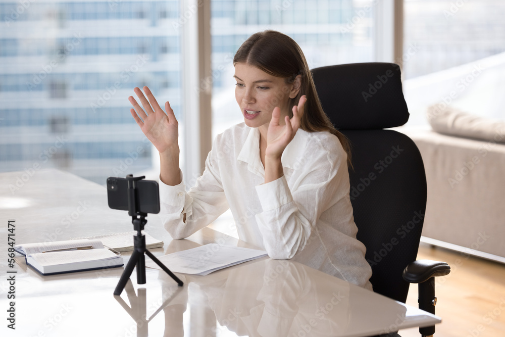 Beautiful young influencer girl recording business podcast, using ...