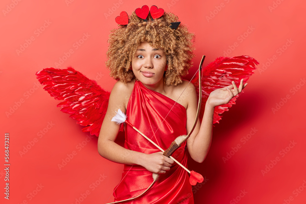 Confused hesitant woman dressed for St Valentines party shrugs ...