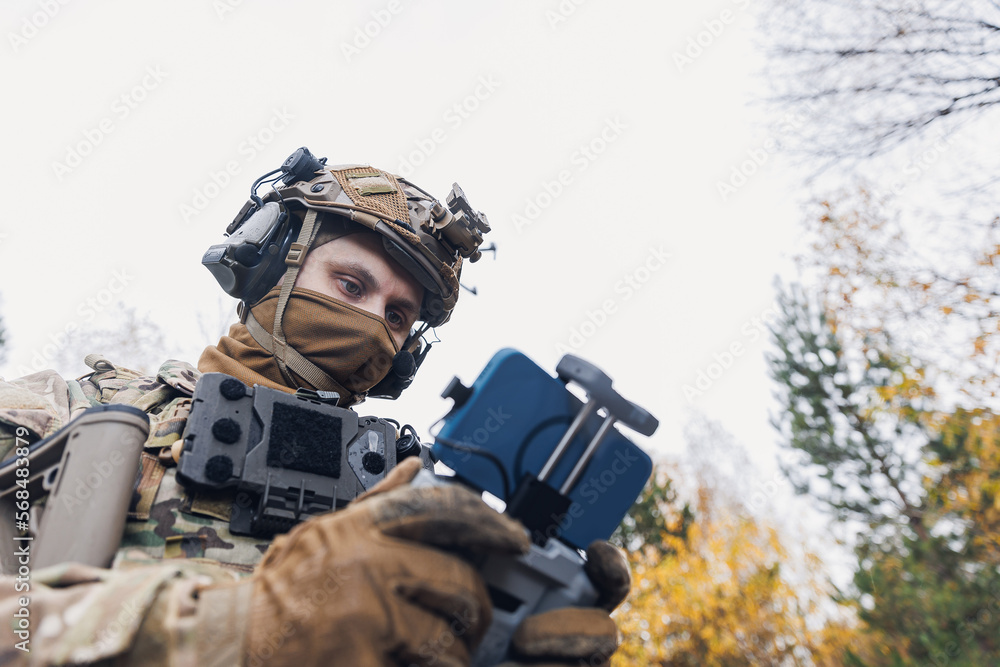 Military soldier controls drone for reconnaissance operation of enemy ...