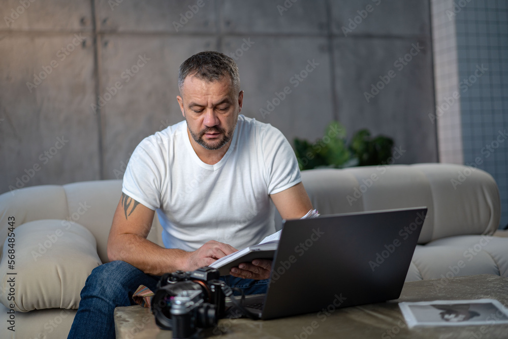 Bearded young confident guy stand behind office desk with laptop ...