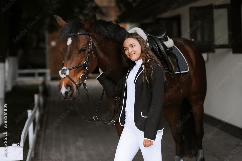 Beautiful professional female jockey standing near horse. woman horse ...