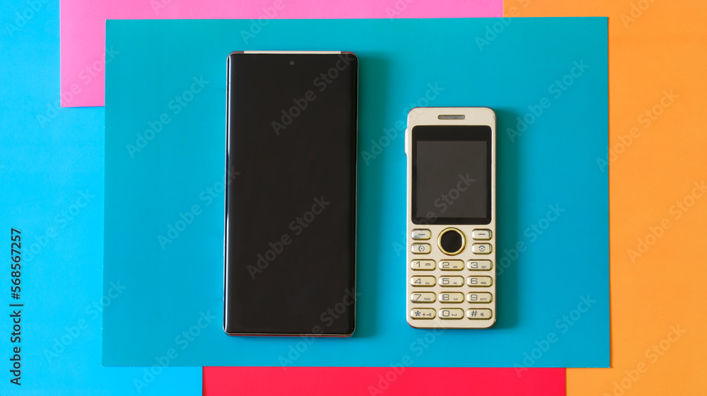 Small push-button mobile phone compared to a modern smartphone ...