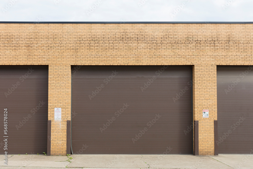 Exterior of industrial warehouse, loading dock roll down doors and ...